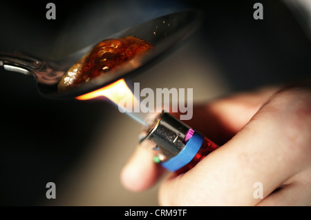 man cooking up drugs on a spoon with a lighter Stock Photo: 49004605 ...