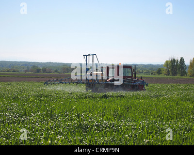 Tractor fertilizing fields Stock Photo - Alamy