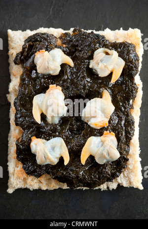 Welsh Laver Bread on Toast with Cockles and Bacon Stock Photo - Alamy