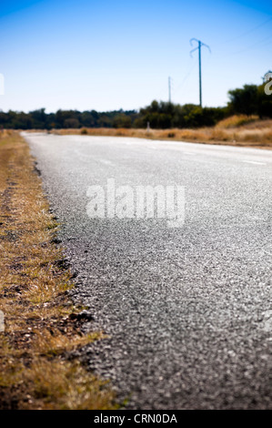 edge of an asphalt road and a roadside with a white line of road ...