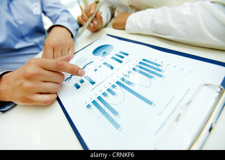 Close-up of graphs and charts analyzed by business people Stock Photo ...