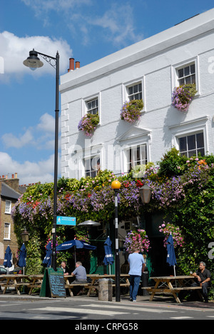 People sitting outside the Hemingford Arms Public House in the sun ...