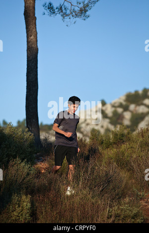 Runner moving through sunlit landscape Stock Photo - Alamy