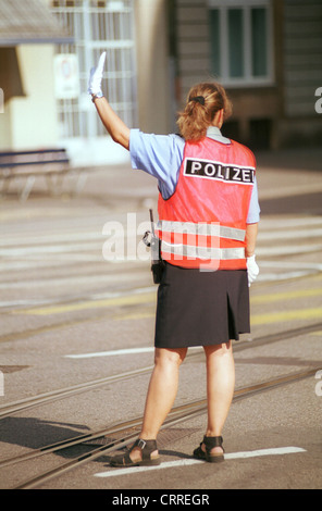 Female Swiss police officer in uniform with equipment, from behind ...