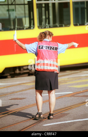 Female Swiss police officer in uniform with equipment, from behind ...