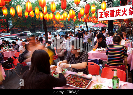 Customers outside as red lanterns hang overhead along Guijie food ...