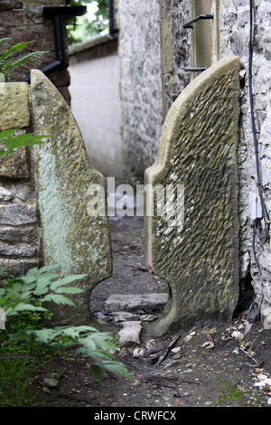 Old stone squeeze stile in drystone wall leading from pasture to ...