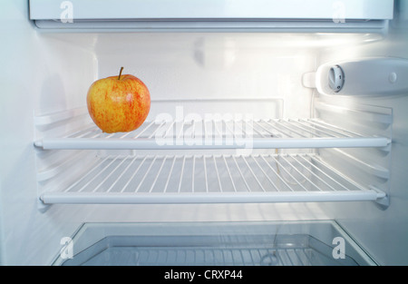 almost empty fridge with an apple Stock Photo - Alamy