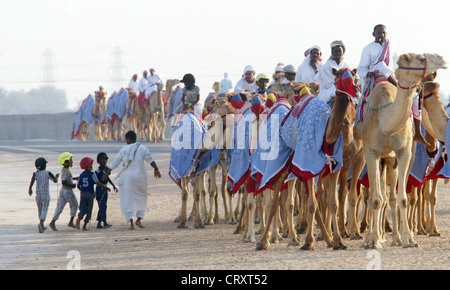 Children camel jockeys at a camel racing, Dubai, UAE 1990s Stock Photo ...