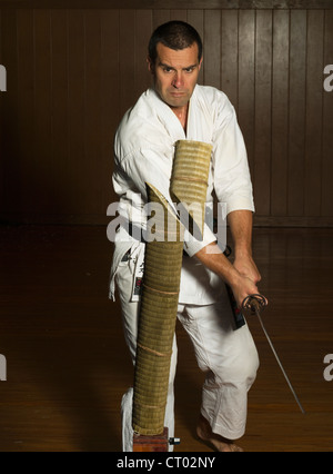 Iaido Tameshigiri training. Slicing rolled tatami matting with a katana ...