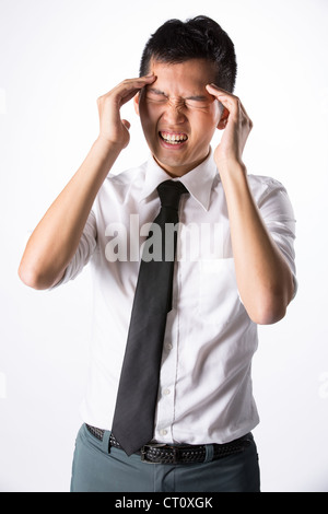 Asian man holding head with headache feeling unwell at home Stock Photo ...