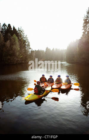 Young people learning kayaking in kayaks on Llyn Padarn Lake in ...