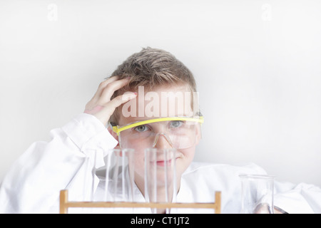 Smiling boy wearing goggles and lab coat in laboratory classroom Stock ...