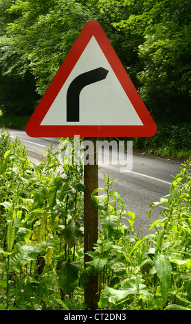 Country road approaching sharp bend and steep gradient Stock Photo - Alamy