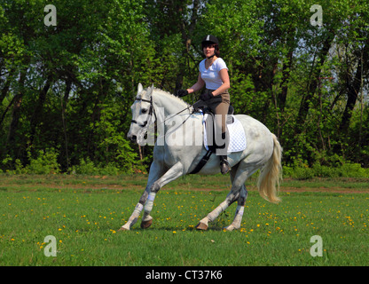 Girl horseback riding English style Stock Photo - Alamy