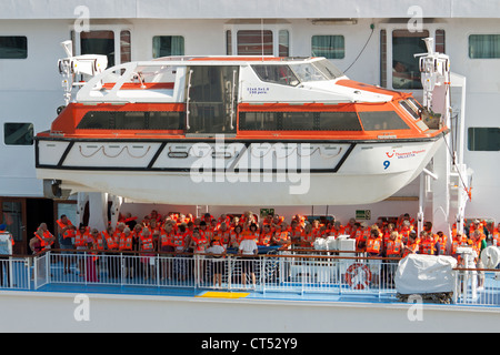 Muster drill with passengers on a cruise ship Stock Photo - Alamy
