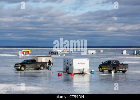 Ice fishing shacks on a frozen harbor at sunrise Stock Photo - Alamy