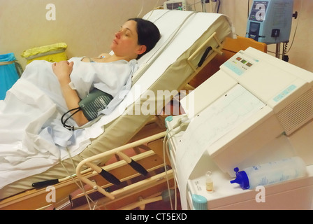 Female patient undergoing an electrocardiography (EKG) examination ...