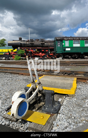 Steam train and track switch levers at the depot of the Chemin de Fer ...