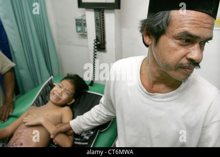 Tsunami - injured and traumatized boy Stock Photo - Alamy