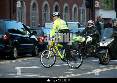 Police bicycle in London street with a policeman writing a ticket for ...