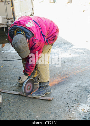 Industrial worker cutting metal with many sparks Stock Photo - Alamy