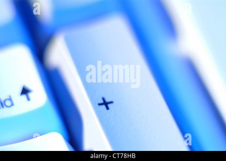 Close up of the plus symbol key on a black calculator keyboard on a ...