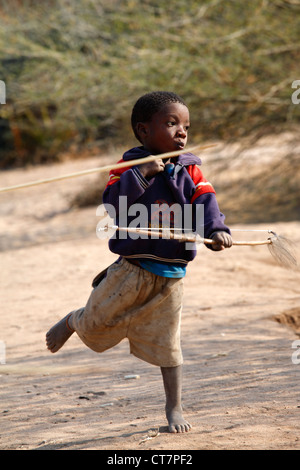 Hadza child practicing archery, Tanzania Stock Photo - Alamy