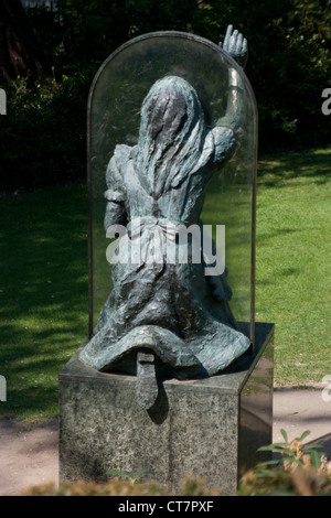 Bronze sculpture of Alice looking through the looking glass by Jean ...