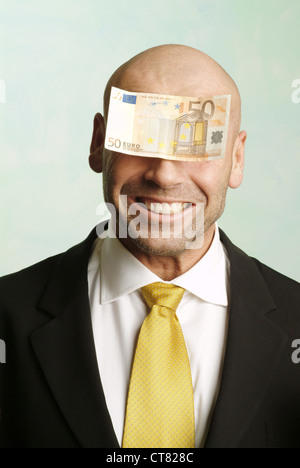 Man with money on his forehead Stock Photo - Alamy