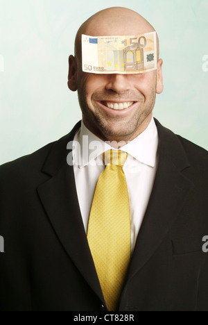 Man with money on his forehead Stock Photo - Alamy