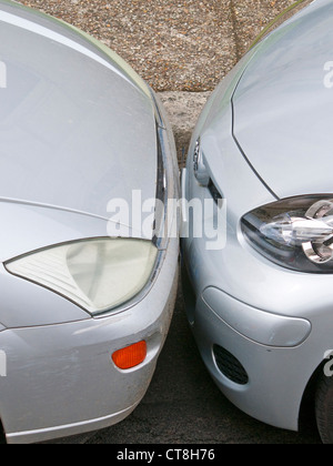 Two cars badly parked bumper to bumper - France Stock Photo - Alamy