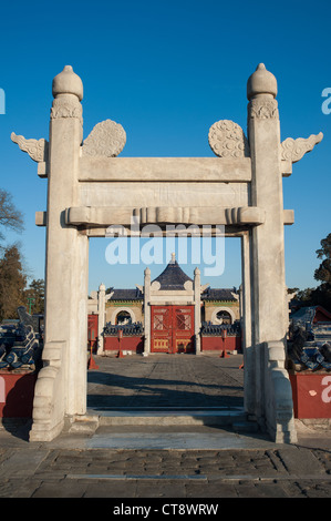 A circular door in red, blue, and yellow stands in front of a stone ...