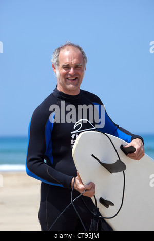 Middle aged Surfer with board on beach at Newquay Stock Photo - Alamy