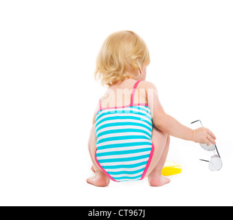 Baby girl in summertime rear view. Girl child relax alone at seaside ...