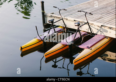 Row of yellow paddle peddle boats Stock Photo - Alamy