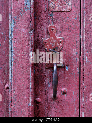old plank door with metal latch, corrugated iron next to it Stock Photo ...