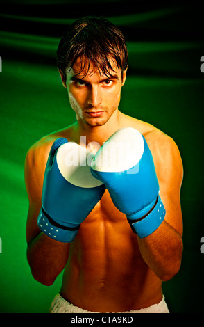 Man sweating all over in boxing gloves Stock Photo - Alamy