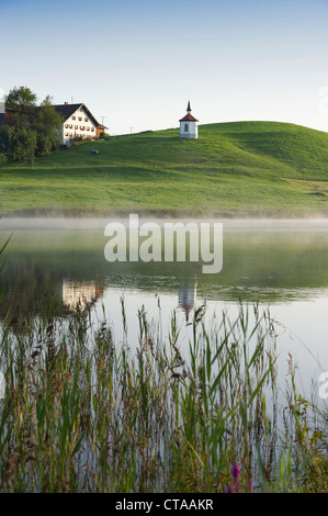 View over lake Hegratsried to chapel royal, Halblech, Allgaeu, Bavaria ...