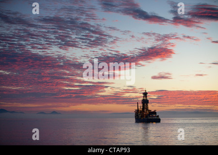 Oil drilling ship Pacific Mistral, Pacific Drilling, at sunrise, near ...