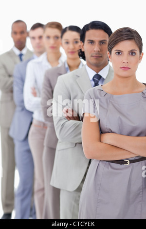 Close-up of workmates in a single line smiling and looking straight ...