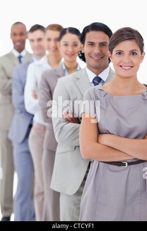 Close-up of workmates in a single line smiling and looking straight ...