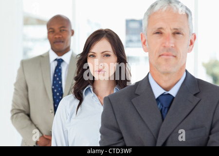 Young businesswoman standing upright between a colleague and her ...