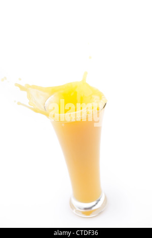 Overlowing glass of orange juice Stock Photo - Alamy