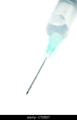 Close-up syringe filled with drug with razor and pack of cocaine. Drug ...