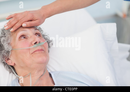Woman doctor touching forehead of sick man on the street Stock Photo ...