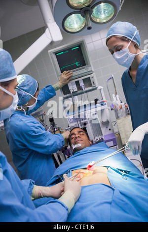 Serious doctors operating a patient Stock Photo - Alamy