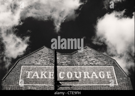 Take Courage slogan of the Courage brewery painted on a building in ...