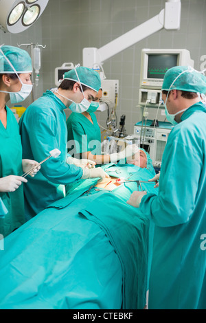 Surgeons around the operating table Stock Photo - Alamy