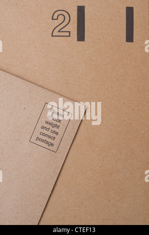 Postage required and postage paid brown return envelopes Stock Photo ...